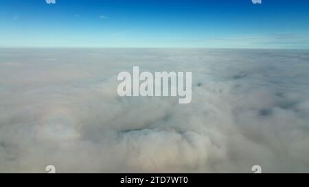 CFlying high above the clouds. Aerial view of clouds and horizon from ...
