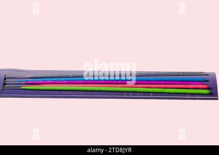 Close-up view of colorful sparklers set against a white background ...