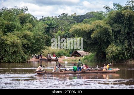 Transport of people across the Mbari river by locally made canoes and ...