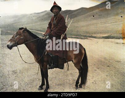 Around Ourga, Mongolia a Mongolian hunter on horseback and armed with a ...