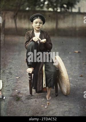 Tonkin, Indochina A young girl in a corner of a courtyard planted with ...