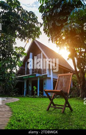 rest house in the valley, you can see trees and lounge chairs in front ...
