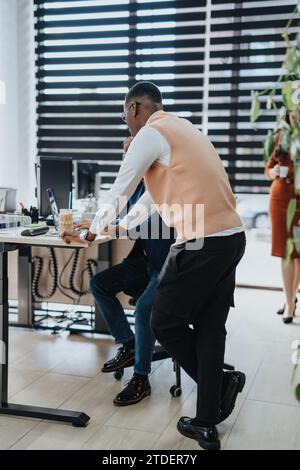 Cross generational business group collaborates in a modern office ...