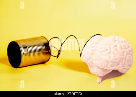 tin can phone with human brain anatomical model. communication concept ...