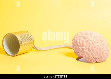 tin can phone with human brain anatomical model. communication concept ...