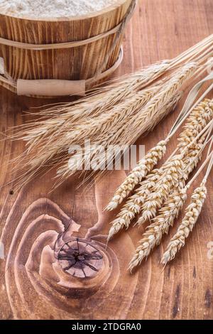 wheat ears with bucket of flour on old wooden board Stock Photo - Alamy