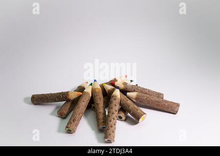 Original colored pencils, made with tree branches of the same size on a ...