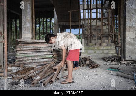 Children forced to work hard at construction site, child labor concept ...