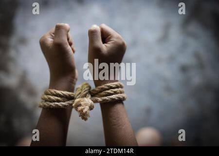 Hopeless man hands tied together with rope, child labor concept, poor ...