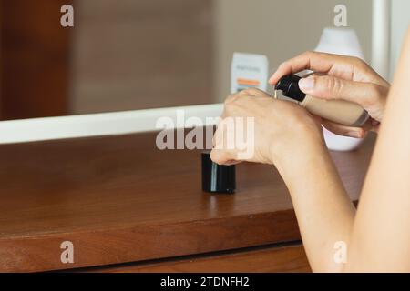 Woman applying cosmetic foundation cream on her hand Stock Photo - Alamy