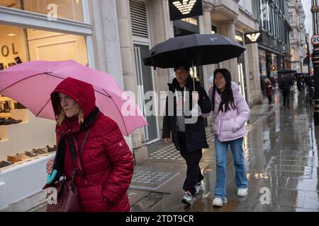 Christmas shoppers along Old Bond Street on a wet winters day, London ...