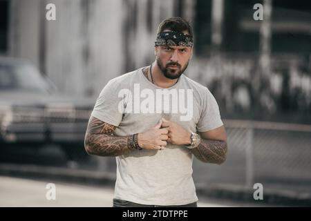 Tattooed gangster on the street. Crime, social issues, drugs. Hispanic ...
