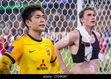 Urawa Reds' goalkeeper Shusaku Nishikawa, center, clears the ball ...