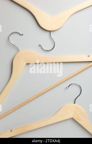 Wooden hangers on light gray background, flat lay. Space for text Stock ...