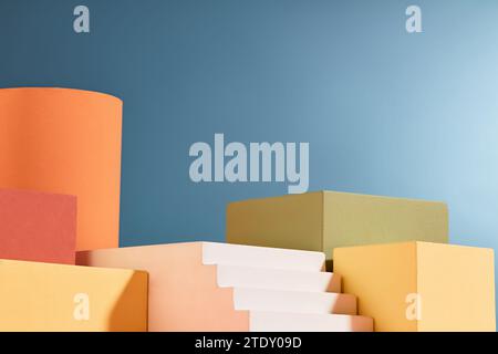 Geometric shape podiums decorated against blue background with vacant ...