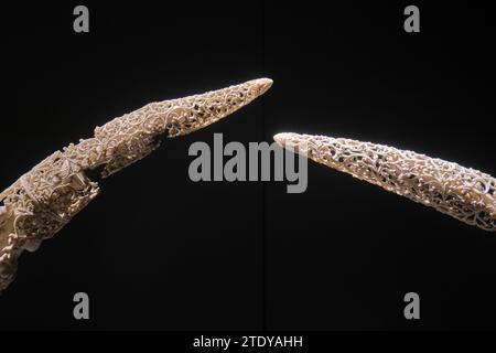 A detail in a display of an intricately carved ivory elephant tusk ...