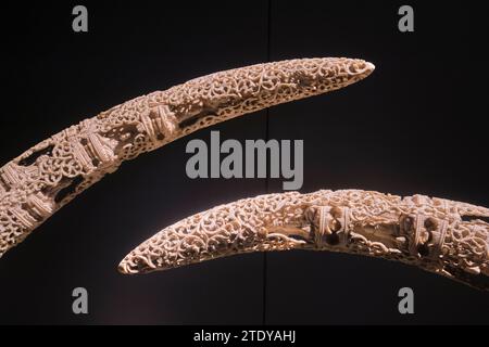 A detail in a display of an intricately carved ivory elephant tusk ...