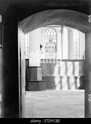 Interior of the Grote Kerk in Edam: benches, windows and a chandelier ...