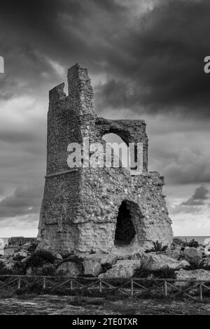 The vertical view of the sea watchtower in the water under the blue sky ...