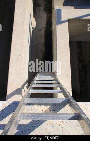 Ladder stands without protection in a sewer in a sewage treatment plant ...