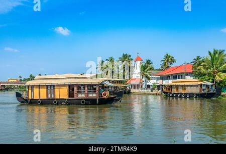 Indian traditional houseboats anchored at Pamba river coastline, with ...