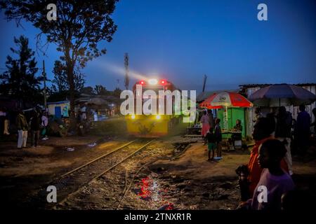 The late evening Nairobi to Kisumu passenger train drives past Kibera ...