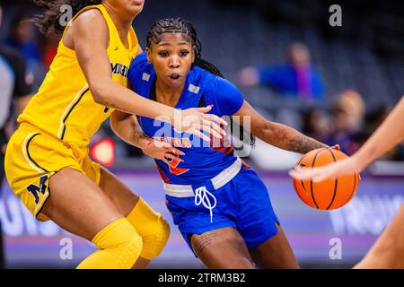 Michigan guard Laila Phelia (5) drives to the basket as Miami forward ...