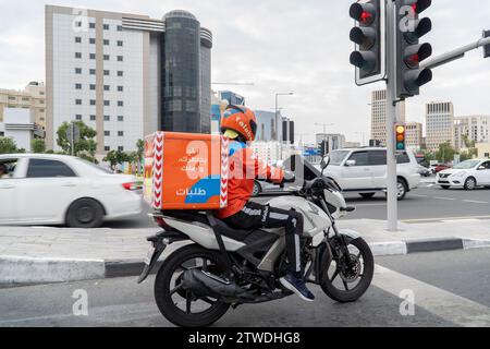Delivery boy Talabat food Delivery rider on Doha road Stock Photo - Alamy