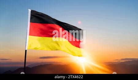 German flag waving against sunrise sky background Stock Photo - Alamy