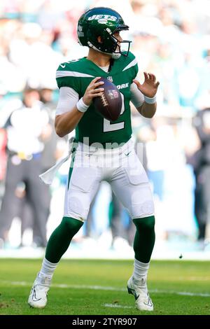 Miami Dolphins quarterback Zach Wilson (0) looks to pass the ball ...