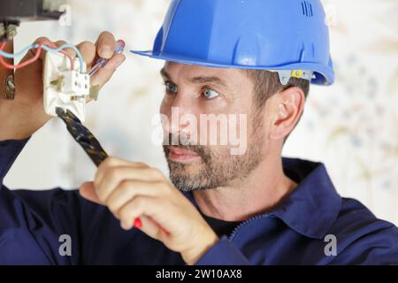 a man doing electrical repairs Stock Photo - Alamy