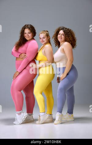 Comfort. Three beautiful women with oversize bodies, wearing sportswear ...