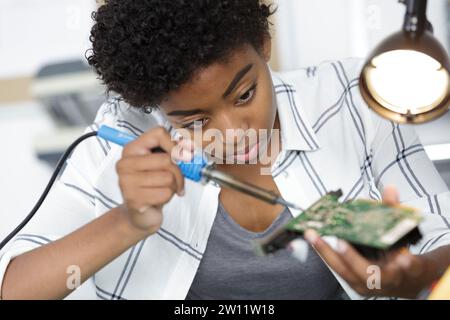 female computer technician using soldering iron Stock Photo - Alamy