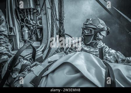Evacuation of a wounded soldier by helicopter. The victim lies on a ...
