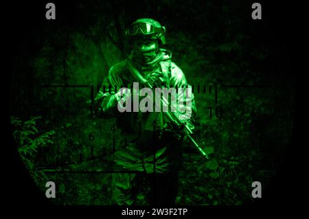 Portrait of a commando in the night sight of a sniper rifle. The ...
