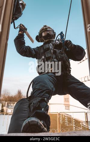 Special forces soldier storms the building through the window. Training ...