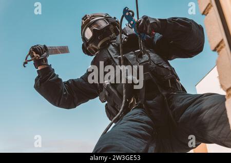 Special forces soldier storms the building through the window. Training ...