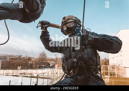 Special forces soldier storms the building through the window. Training ...