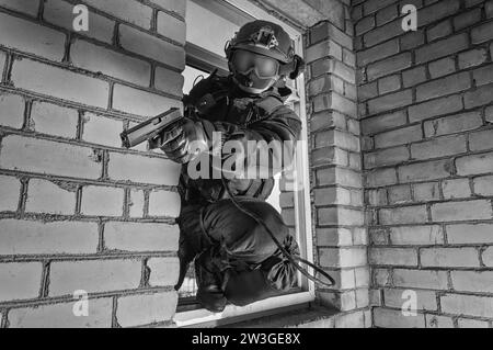 Special forces soldier storms the building through the window. Training ...