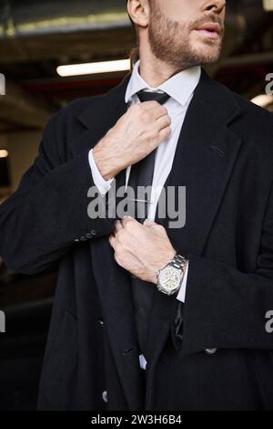 Handsome and attractive businessman is fixing his coat while walking ...