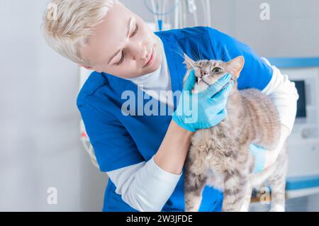 Image of a beautiful blonde nurse in a surgical suit. Examination of a ...
