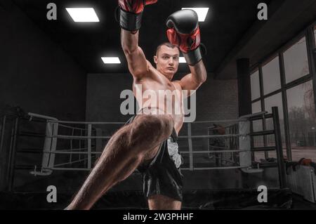 Image of a kickboxer in the gym. Knee kick. Mixed martial arts. Sports ...