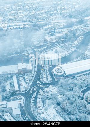 A snow-covered city dominated by winter fog photographed from the air ...