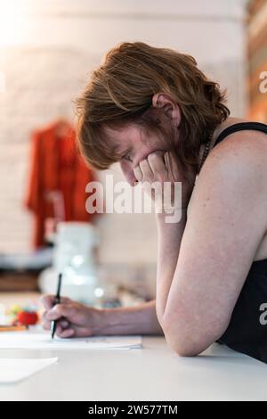 Female fashion designer creating new wedding dress design Stock Photo ...