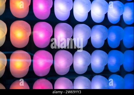 Luminous Contrast. Neon Light Bulb Fixture in the Dark. Red flame ...