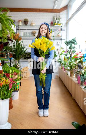 Positive young saleswoman holding fresh melon during offering fresh ...