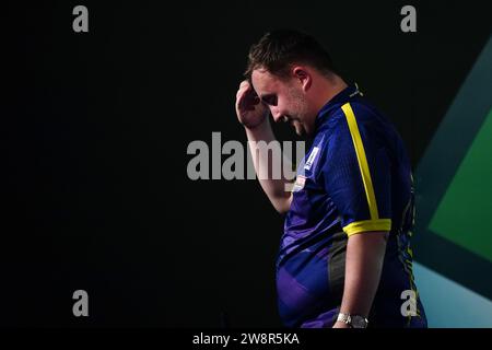 Luke Littler reacts after beating Andrew Gilding (not pictured) on day ...