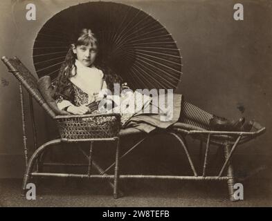 Xie Kitchin partly in the Penelope Boothby dress, on a garden chair ...