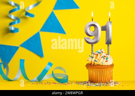 Lighted birthday candle number 91 - Yellow background with blue ...