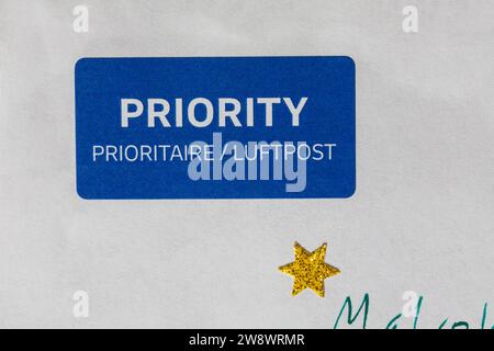 Priority sticker stuck on white envelope Stock Photo - Alamy